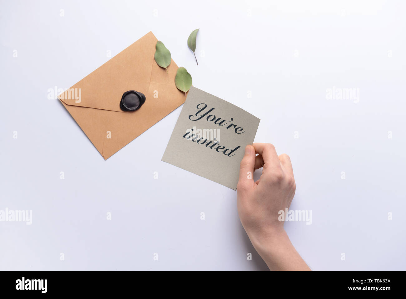 Female hand with invitation and envelope on white background Stock ...