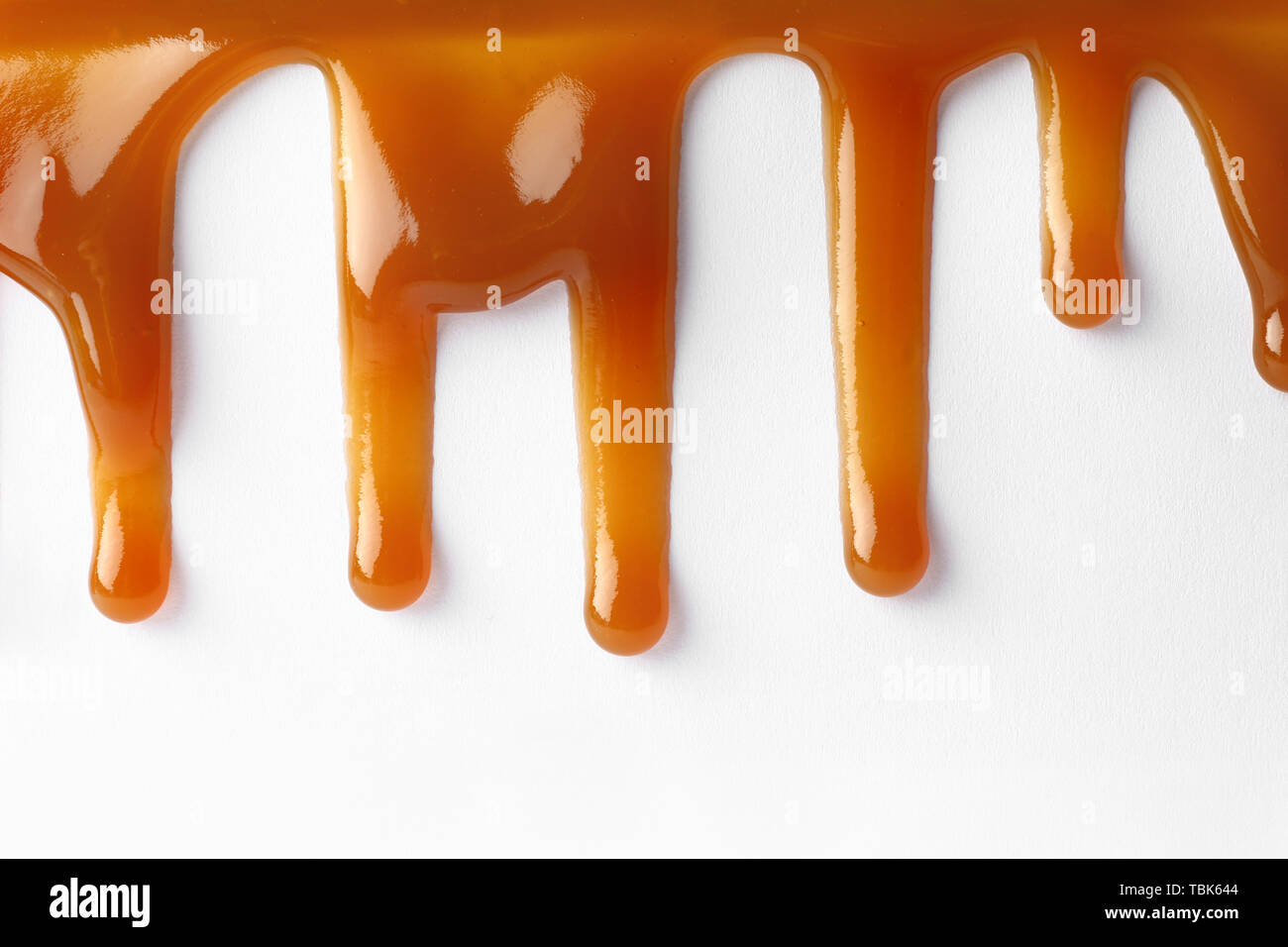 Stains of liquid caramel on white background Stock Photo - Alamy