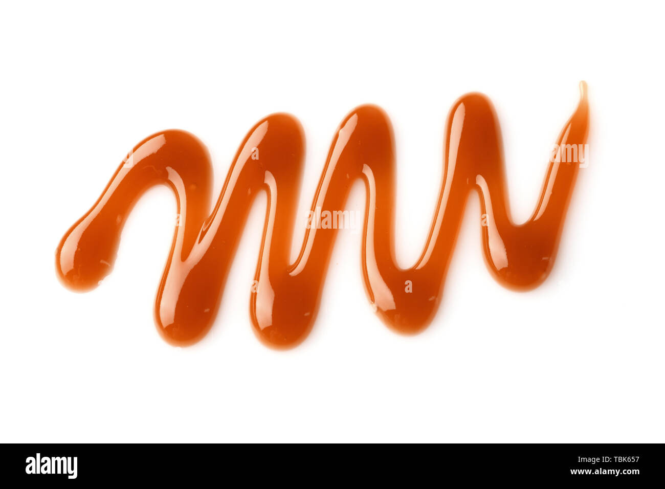 Liquid caramel on white background Stock Photo - Alamy