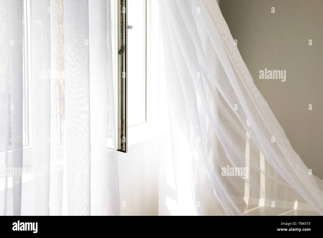 Open window with light curtains in room Stock Photo - Alamy