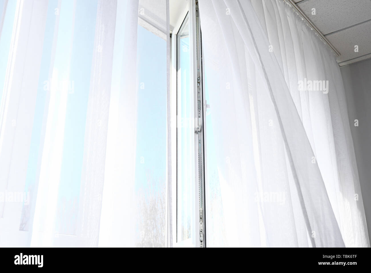 Open window with light curtains in room Stock Photo - Alamy