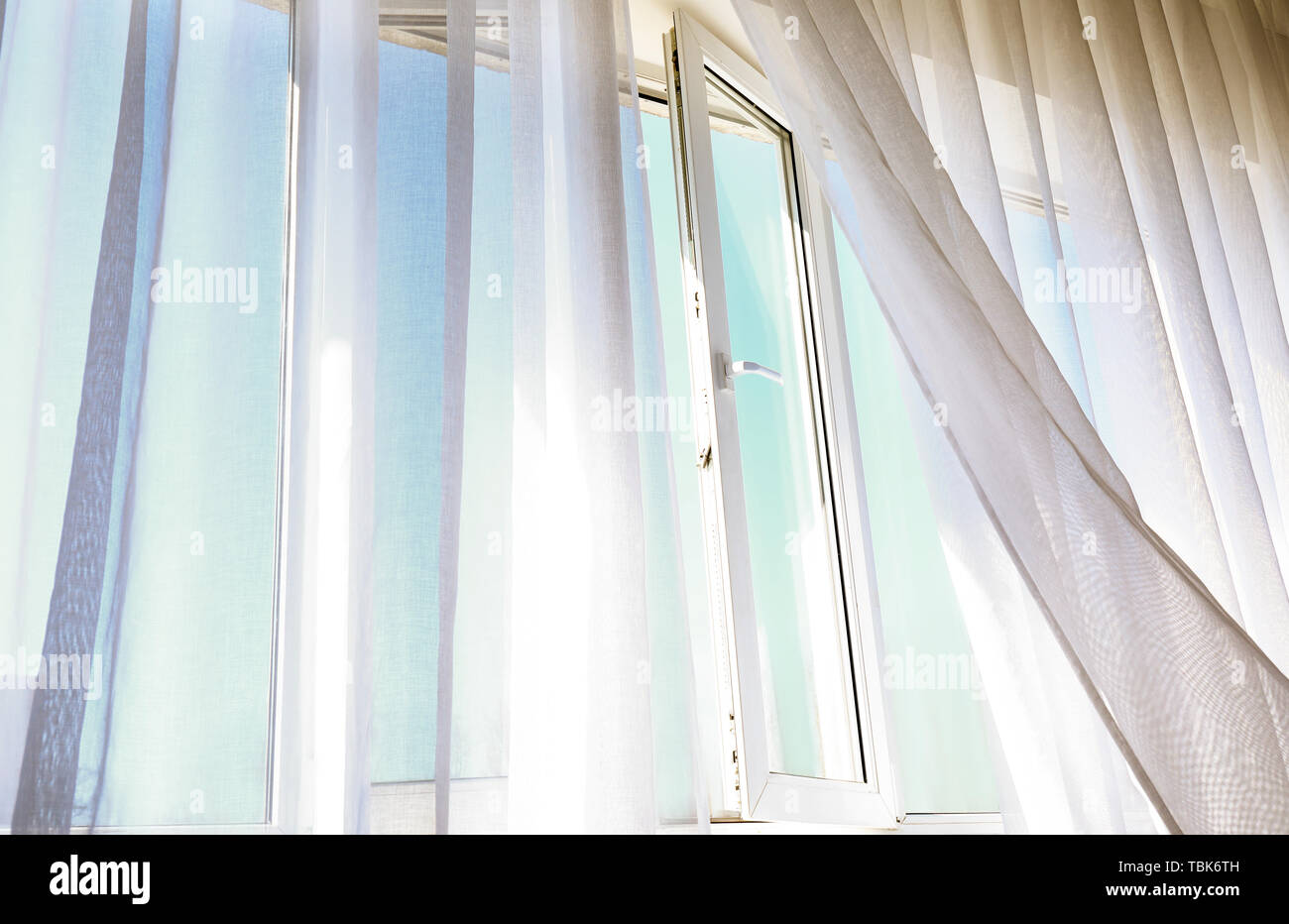 Open window with light curtains in room Stock Photo - Alamy