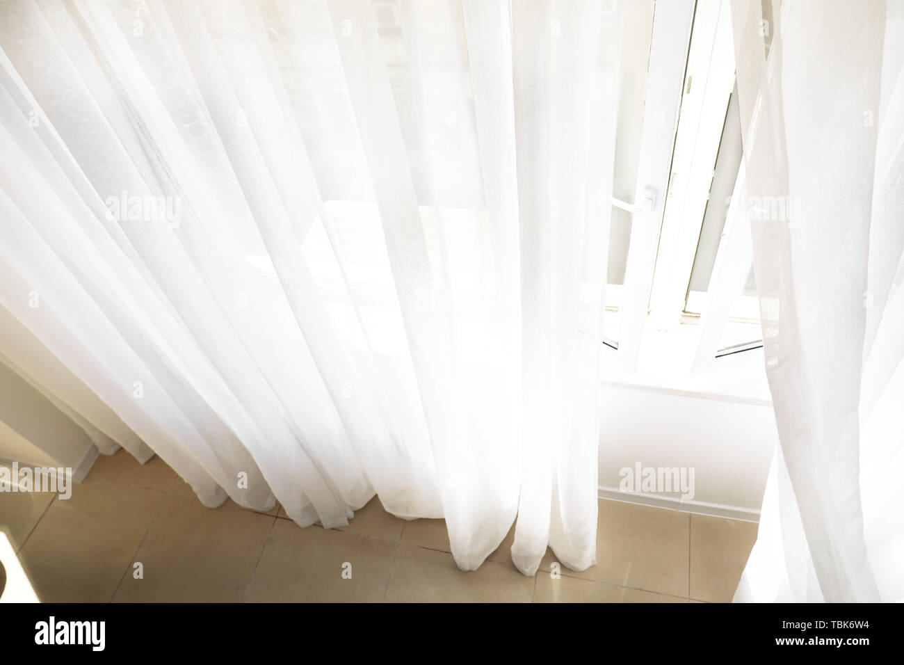 Open window with light curtains in room Stock Photo - Alamy