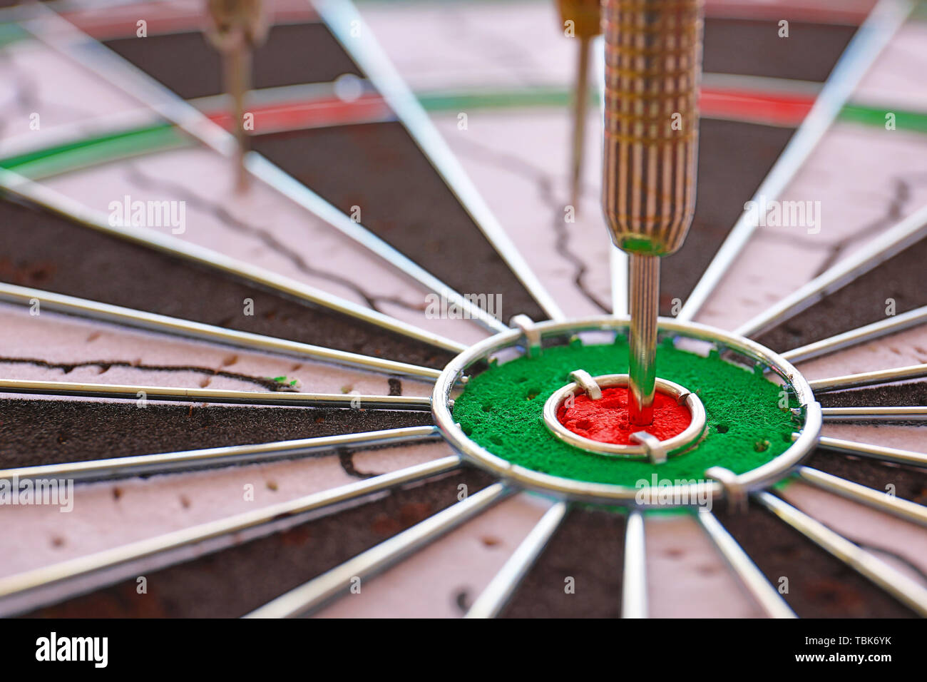Dartboard with hit bullseye, closeup Stock Photo - Alamy