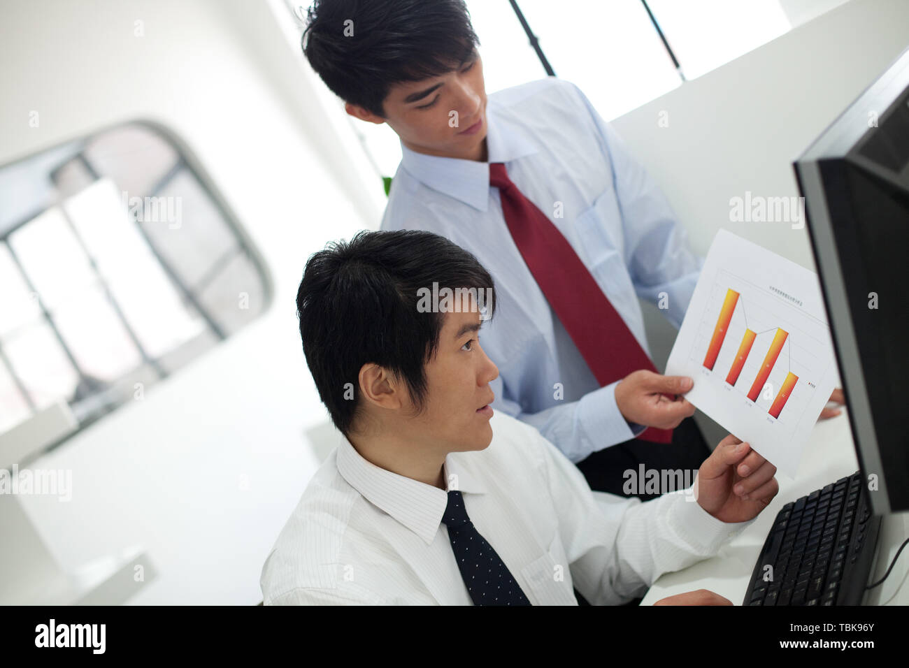 A discussion in front of a computer Stock Photo - Alamy