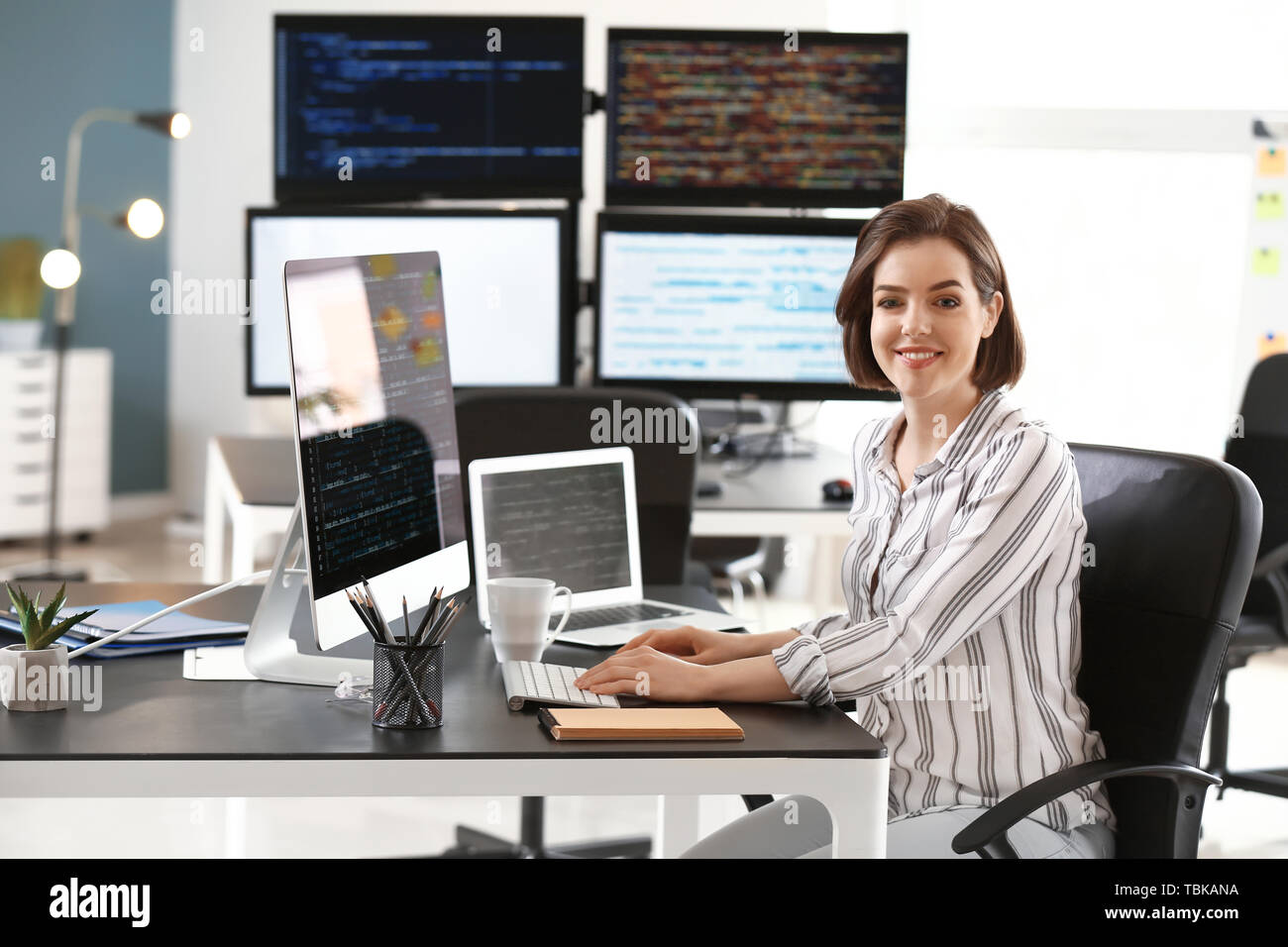 Female programmer working in office Stock Photo - Alamy