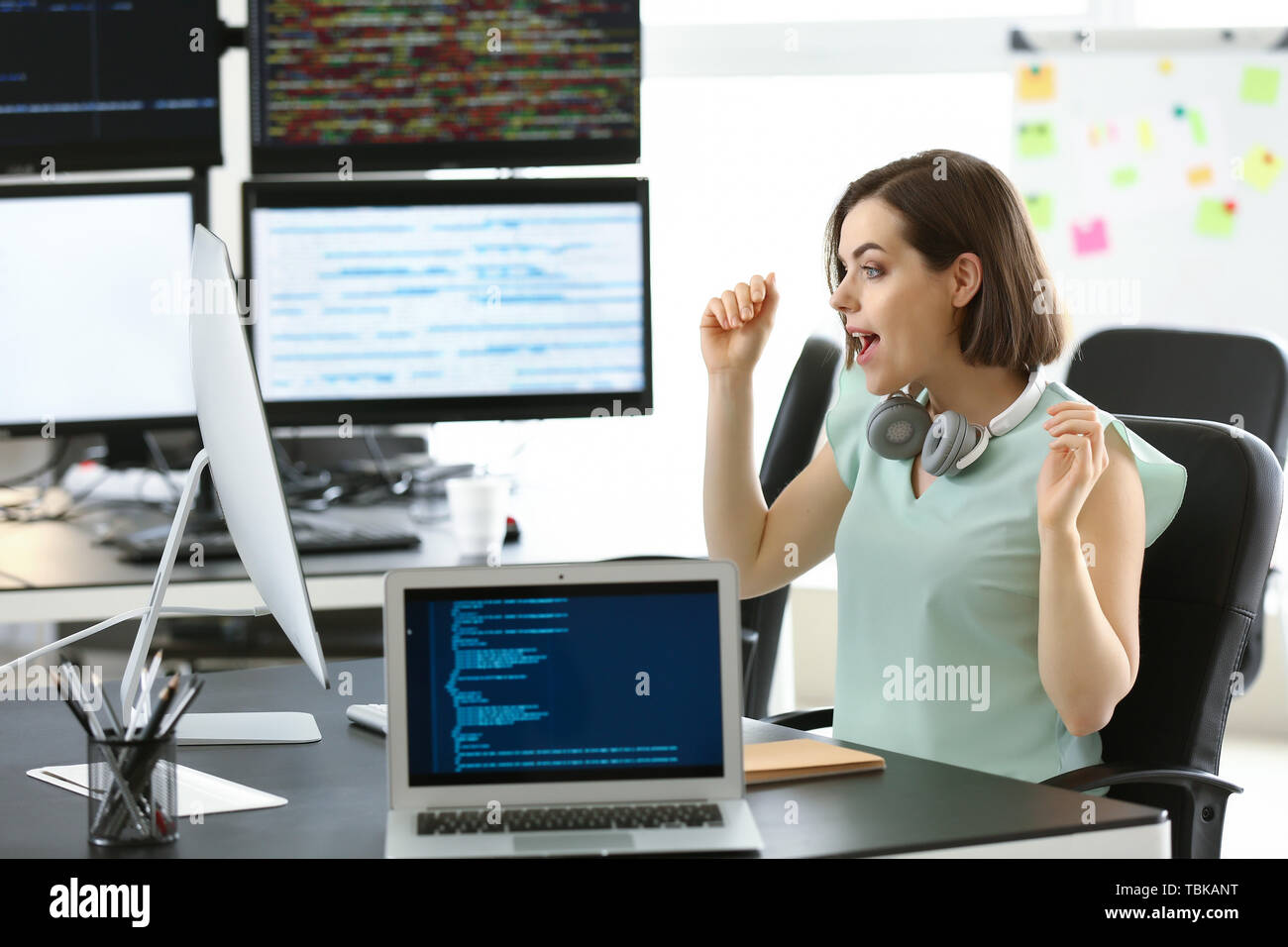 Happy female programmer working in office Stock Photo - Alamy