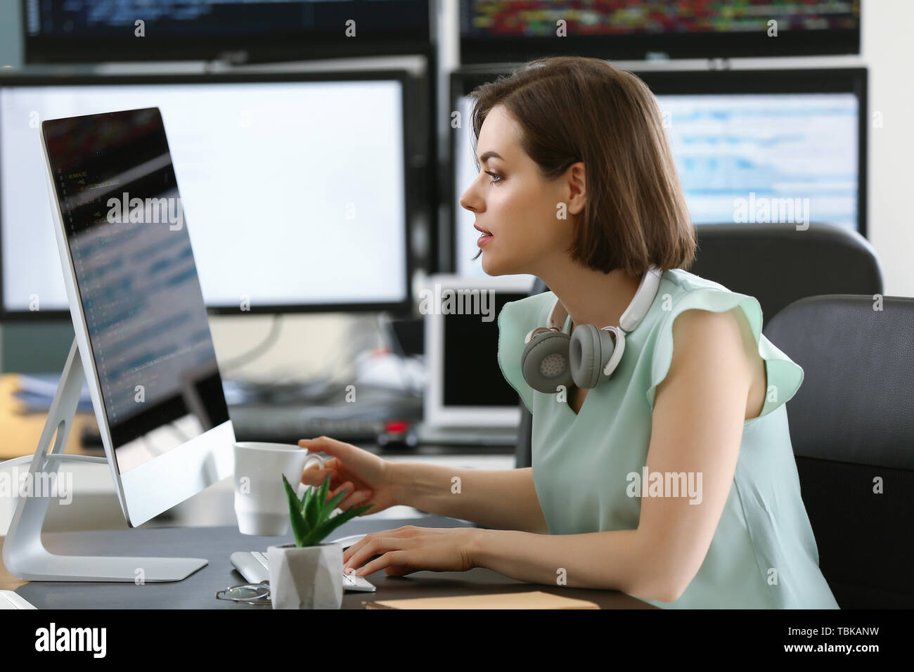 Female programmer working in office Stock Photo - Alamy