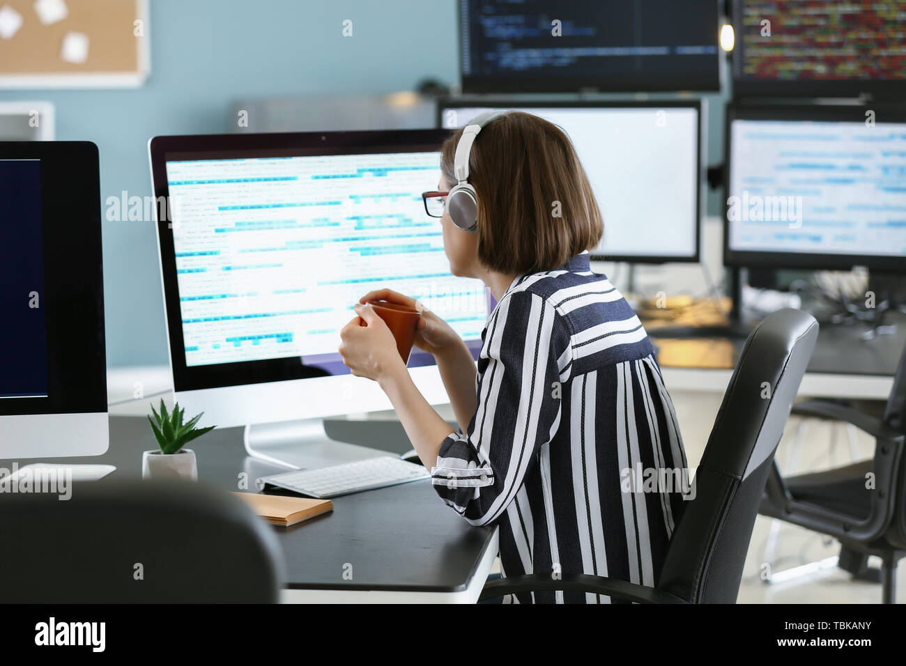 Female programmer working in office Stock Photo - Alamy
