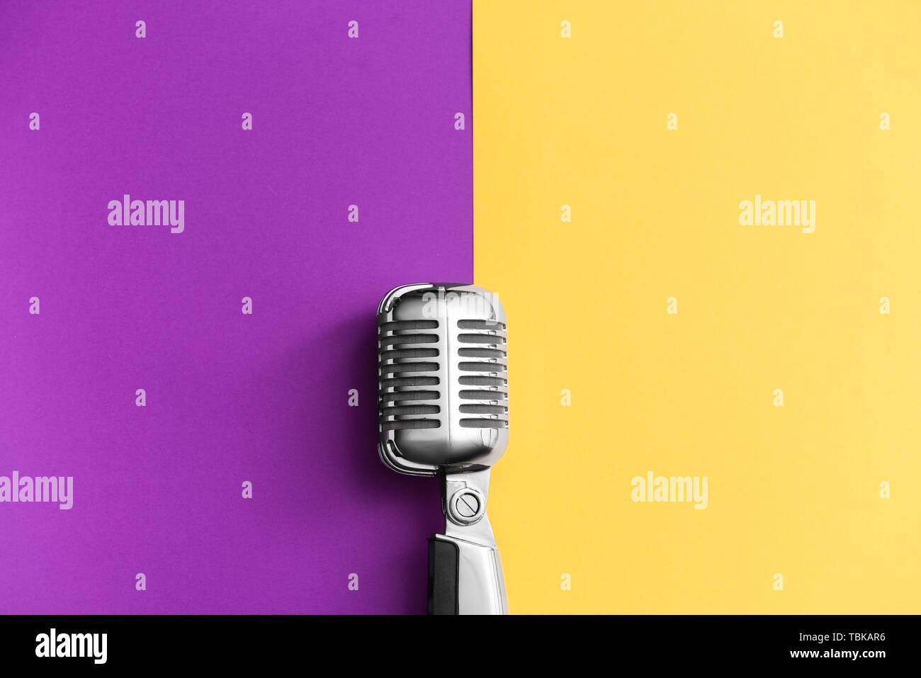 Retro microphone on color background Stock Photo - Alamy