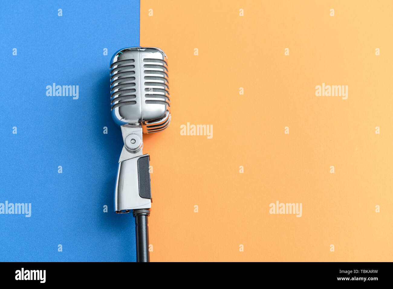 Retro microphone on color background Stock Photo - Alamy
