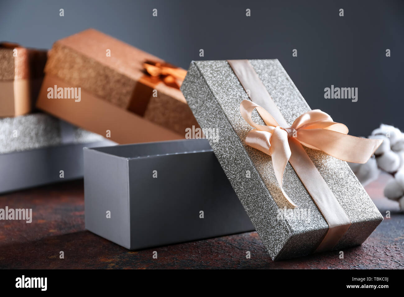 Open gift box on table Stock Photo - Alamy