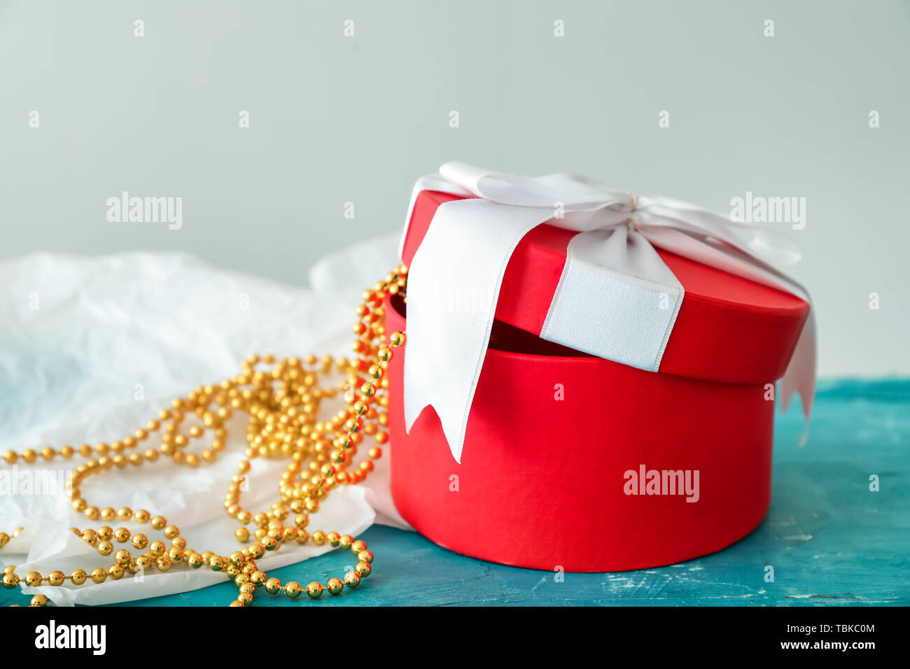 Gift box on color table Stock Photo - Alamy