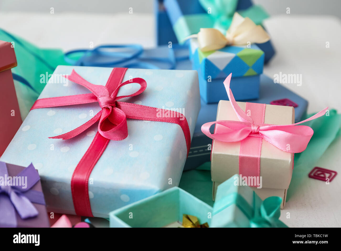 Different gift boxes on white table Stock Photo - Alamy