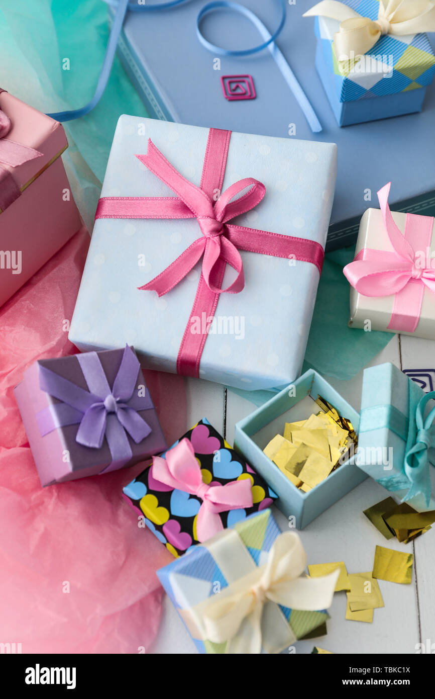 Different gift boxes on white table Stock Photo - Alamy