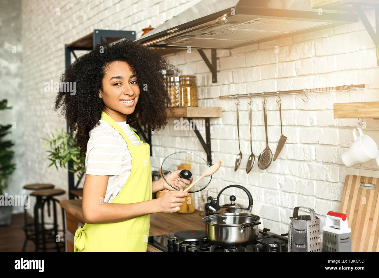 African-American woman cooking in kitchen Stock Photo - Alamy