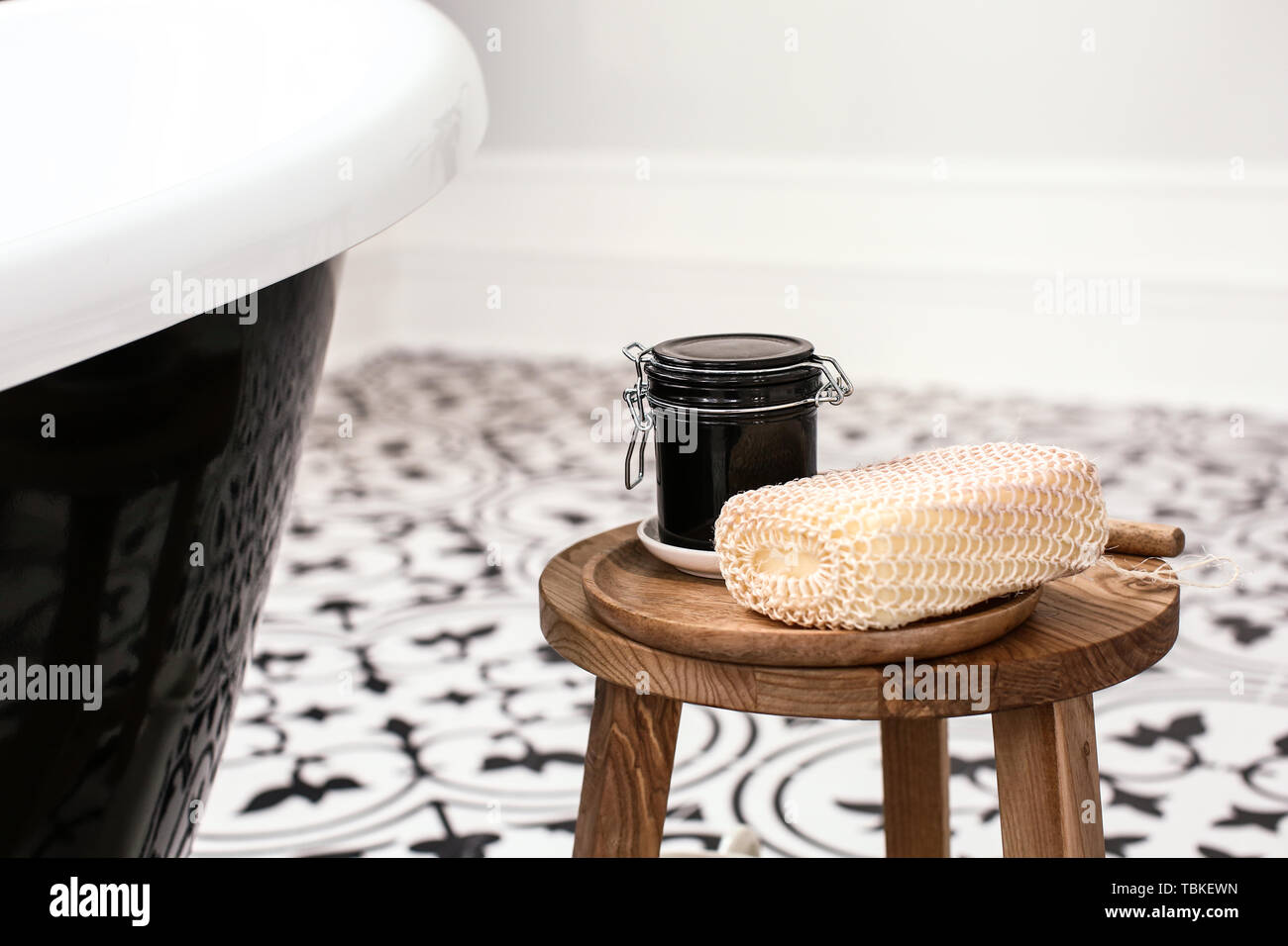 Jar of cream with wisp of bast on wooden stool in bathroom Stock Photo ...