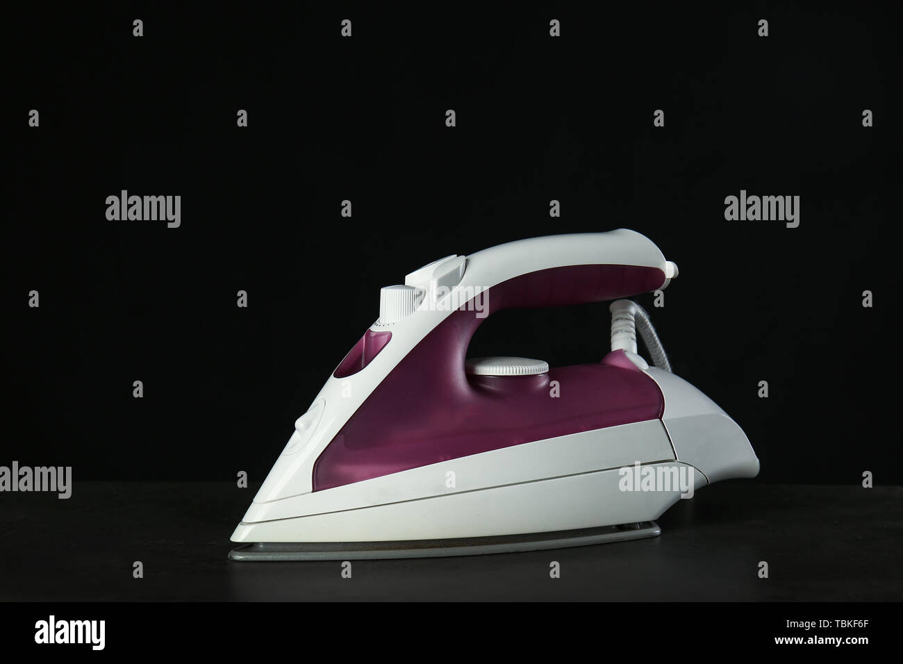 Modern iron on black background Stock Photo - Alamy