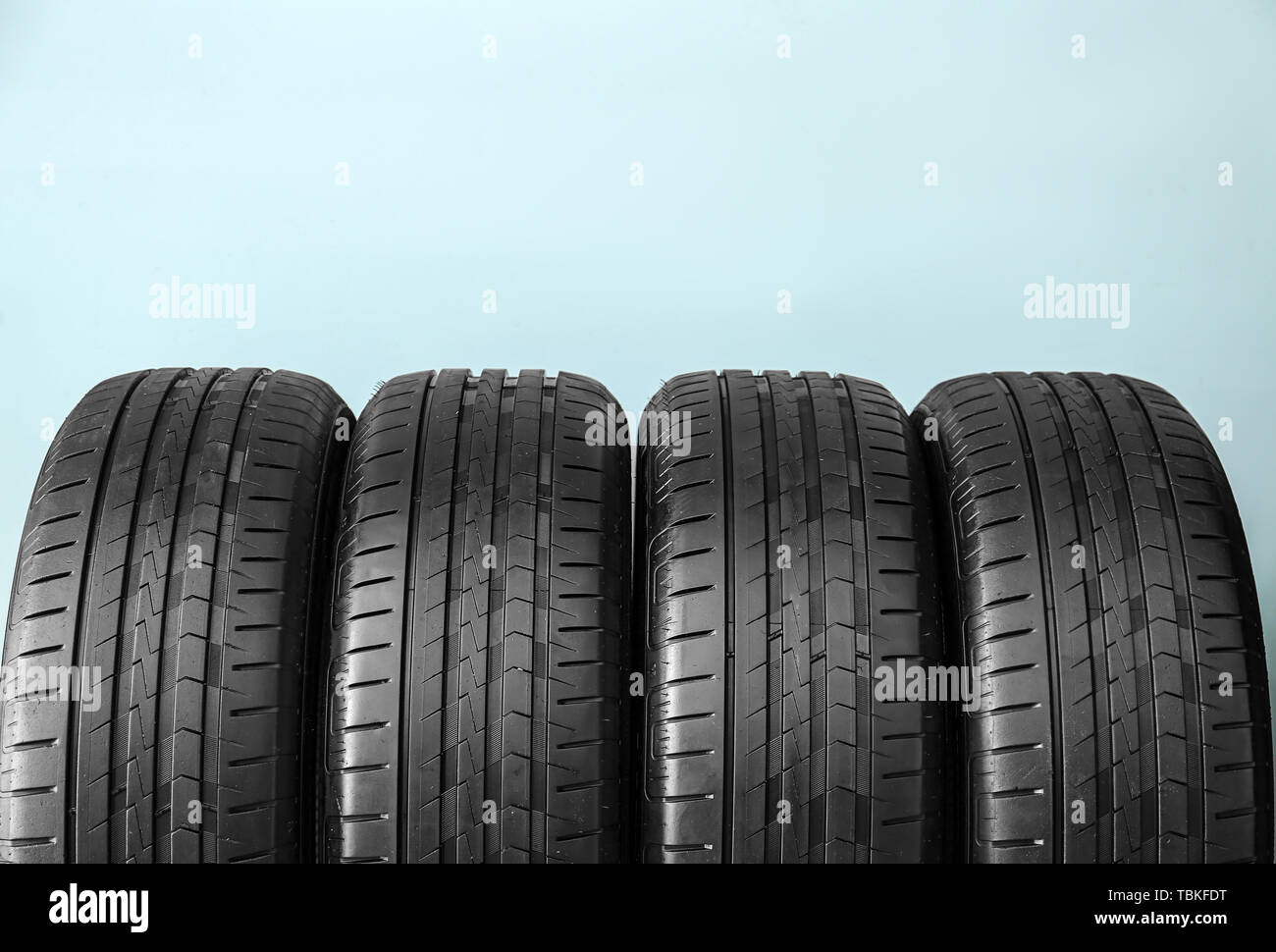 Car tires on color background Stock Photo - Alamy