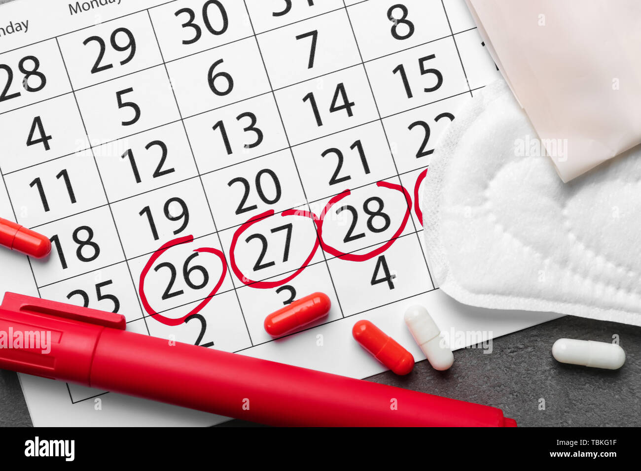Menstrual calendar with pills and pad on grey background Stock Photo ...