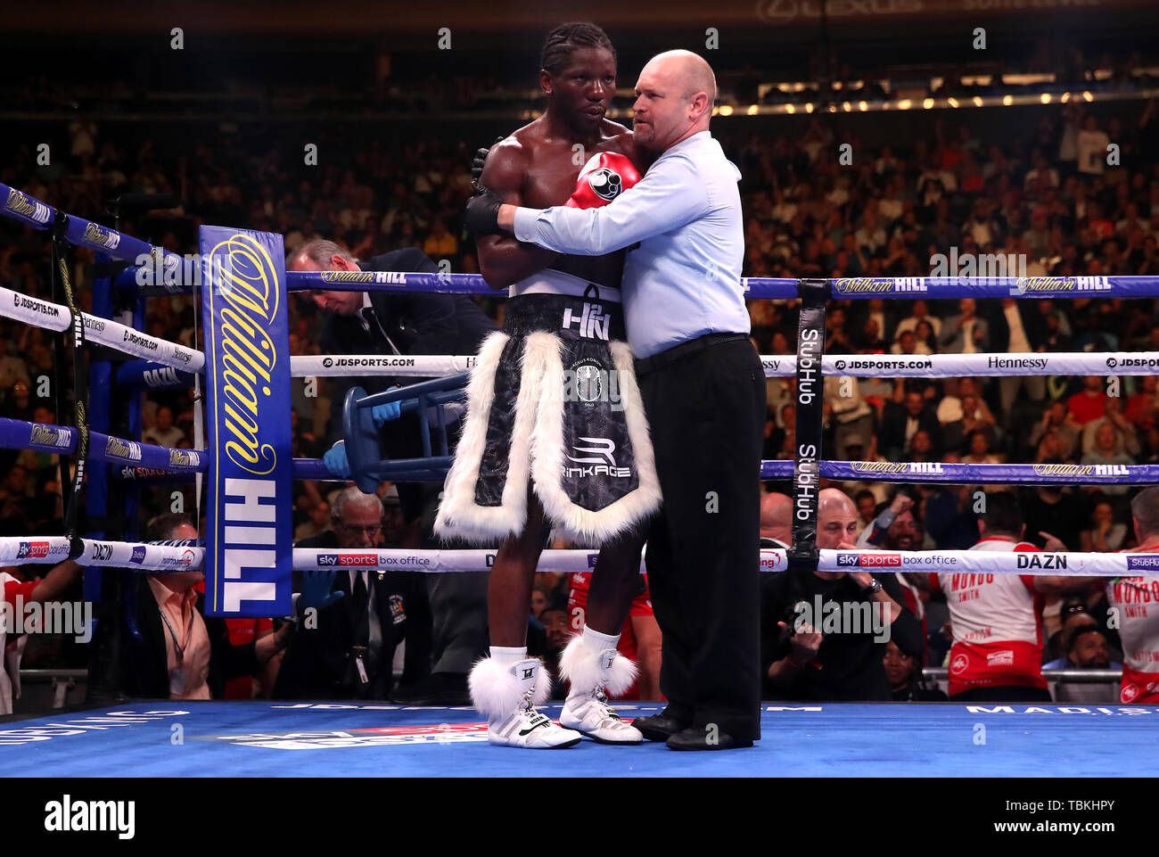 Referee Charlie Fitch (right) stops the fight between Hassan N'Dam ...