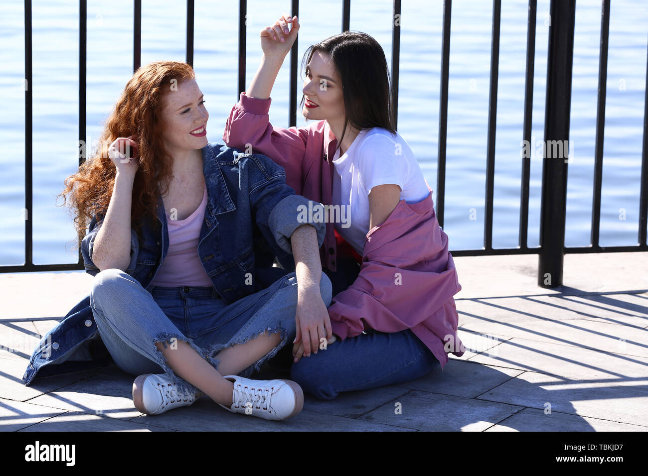Fashionable young women on bridge Stock Photo - Alamy