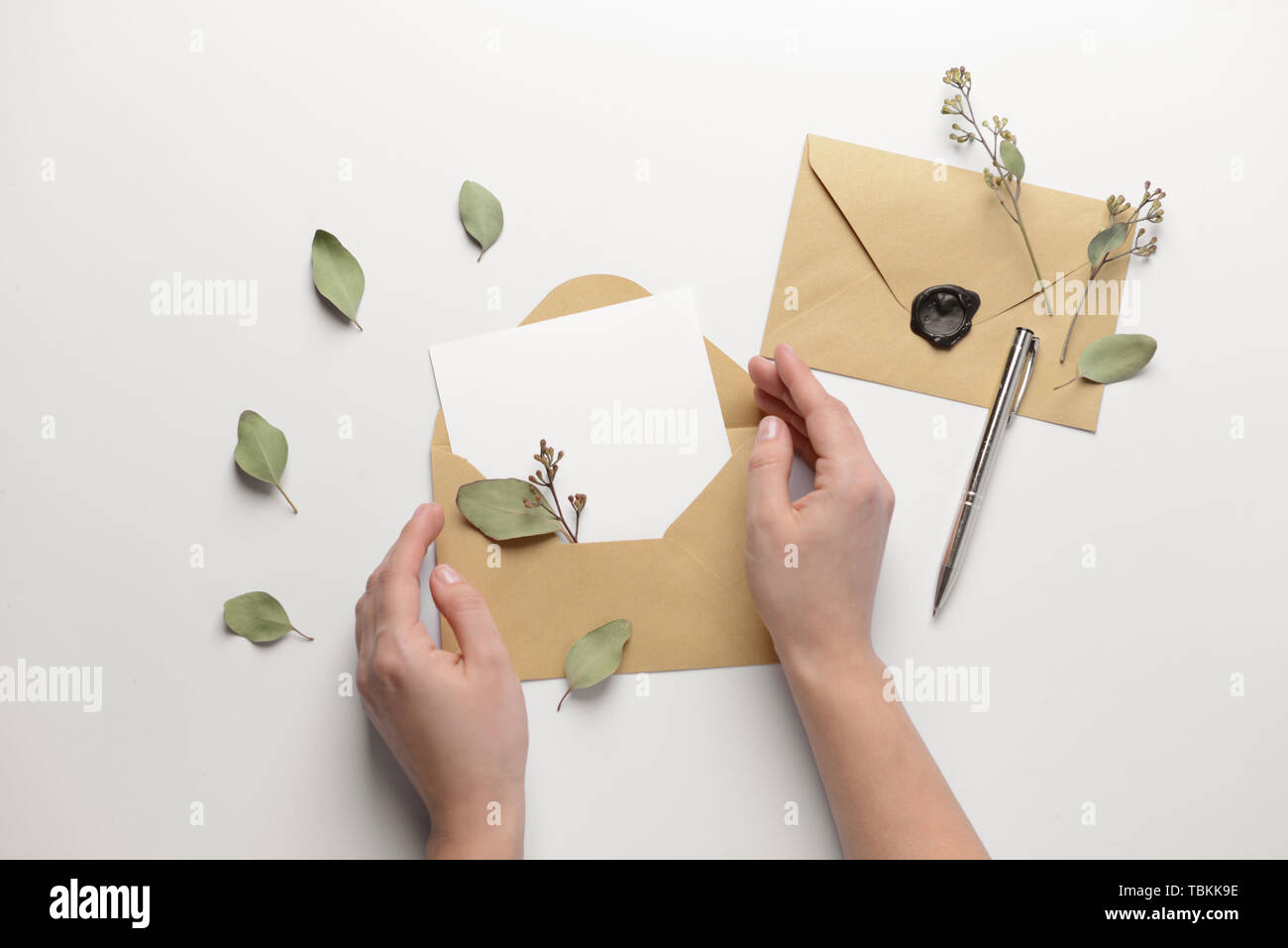 Female hands with invitation on white background Stock Photo - Alamy