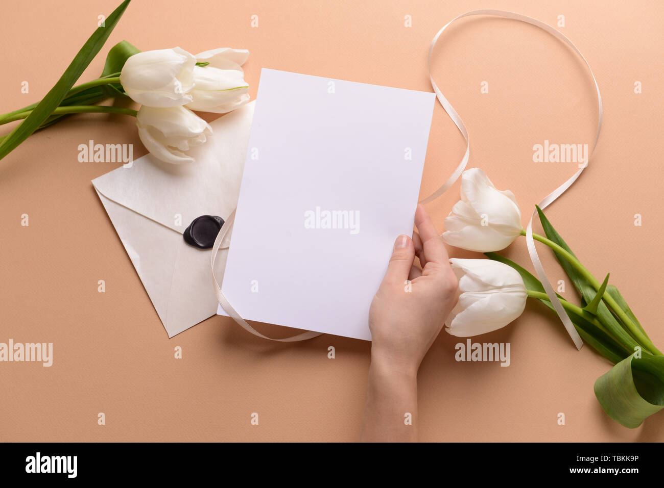 Female hand with invitation on color background Stock Photo - Alamy
