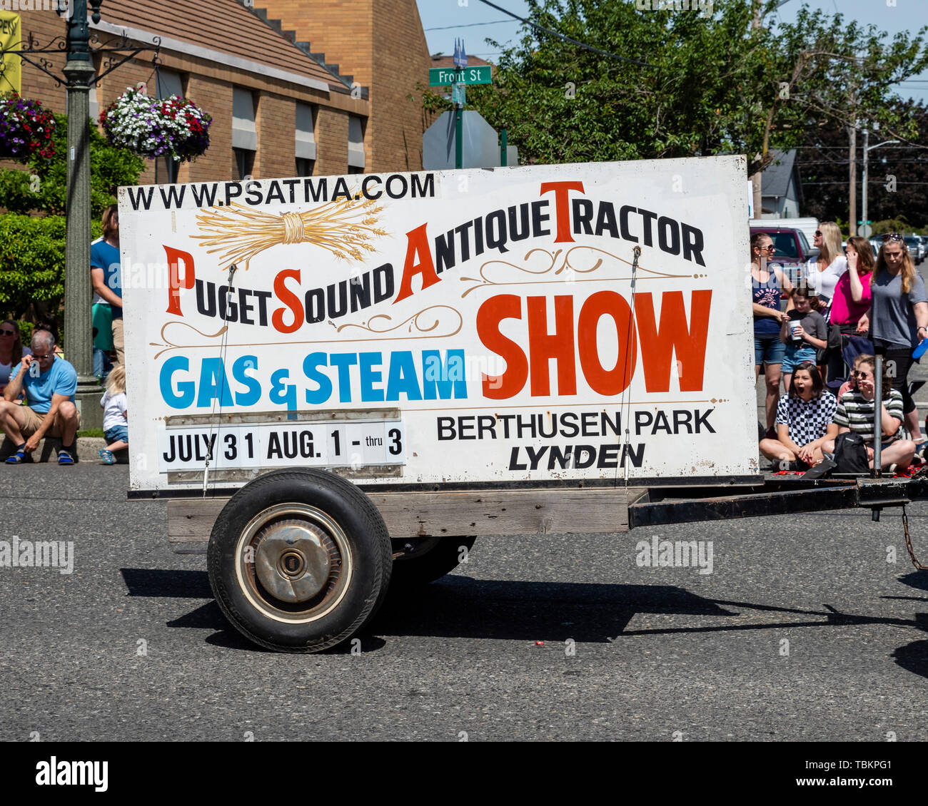 Rolling sign for the Puget Sound Antique Tractor Show marches in the ...