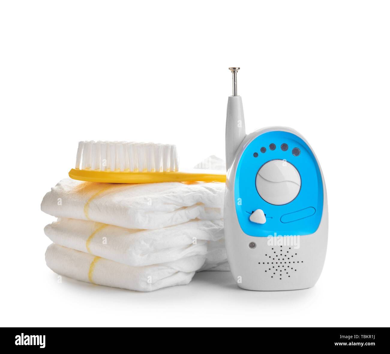 Modern baby monitor with diapers and brush on white background Stock ...