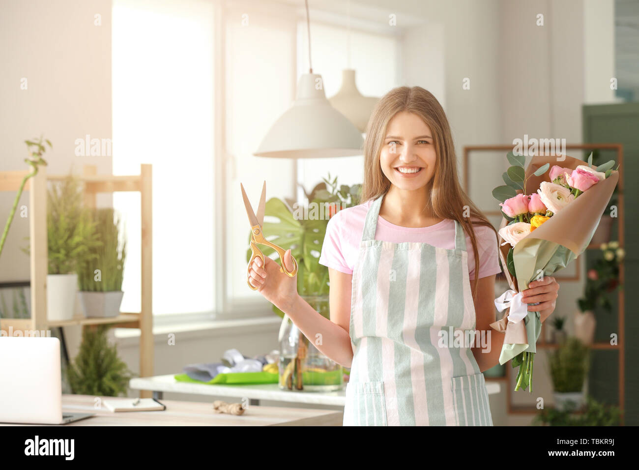 Female florist in uniform hi-res stock photography and images - Alamy