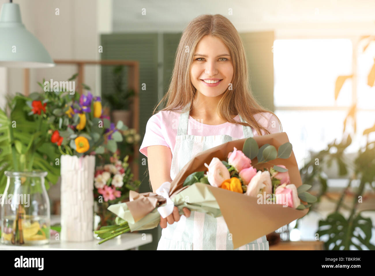Female florist with beautiful bouquet in shop Stock Photo - Alamy
