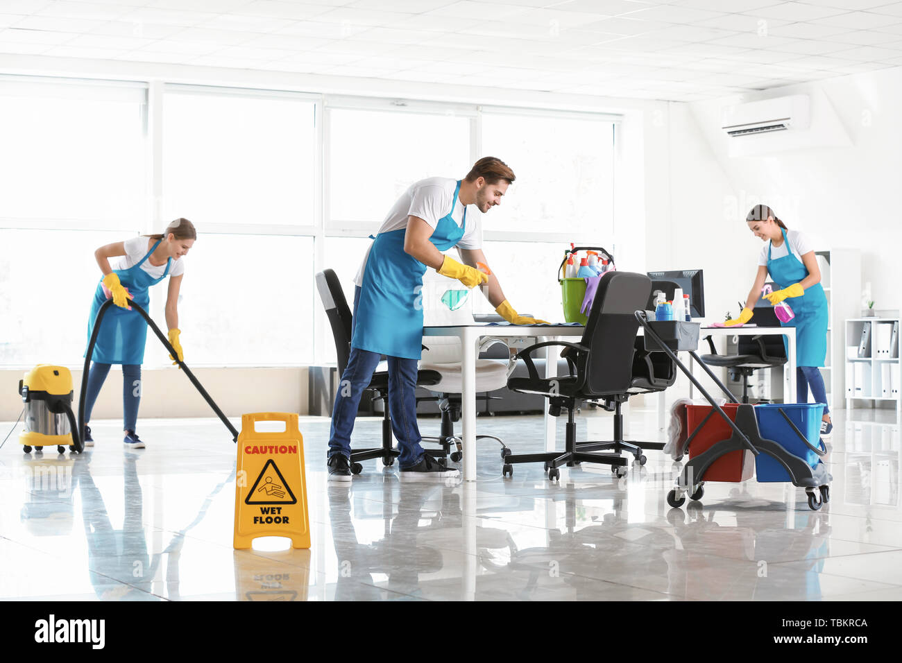 Team of janitors cleaning office Stock Photo - Alamy