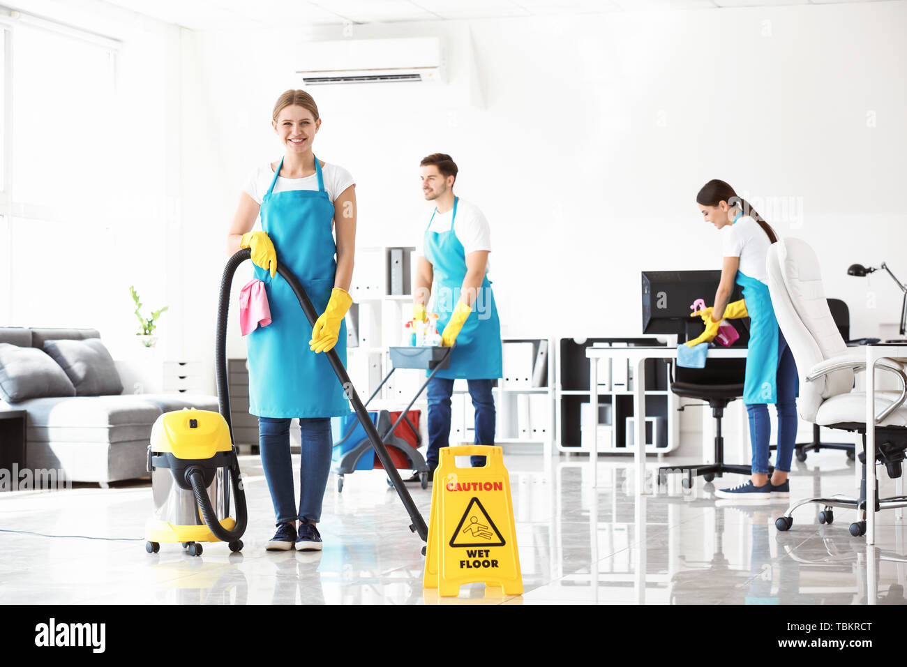 Team of janitors cleaning office Stock Photo - Alamy