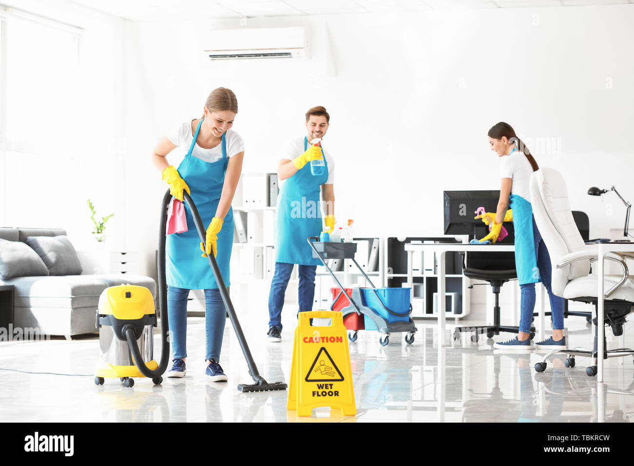 Team of janitors cleaning office Stock Photo - Alamy