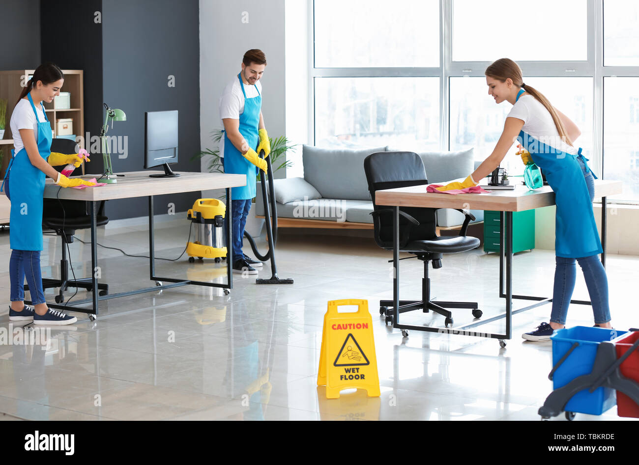 Team of janitors cleaning office Stock Photo - Alamy