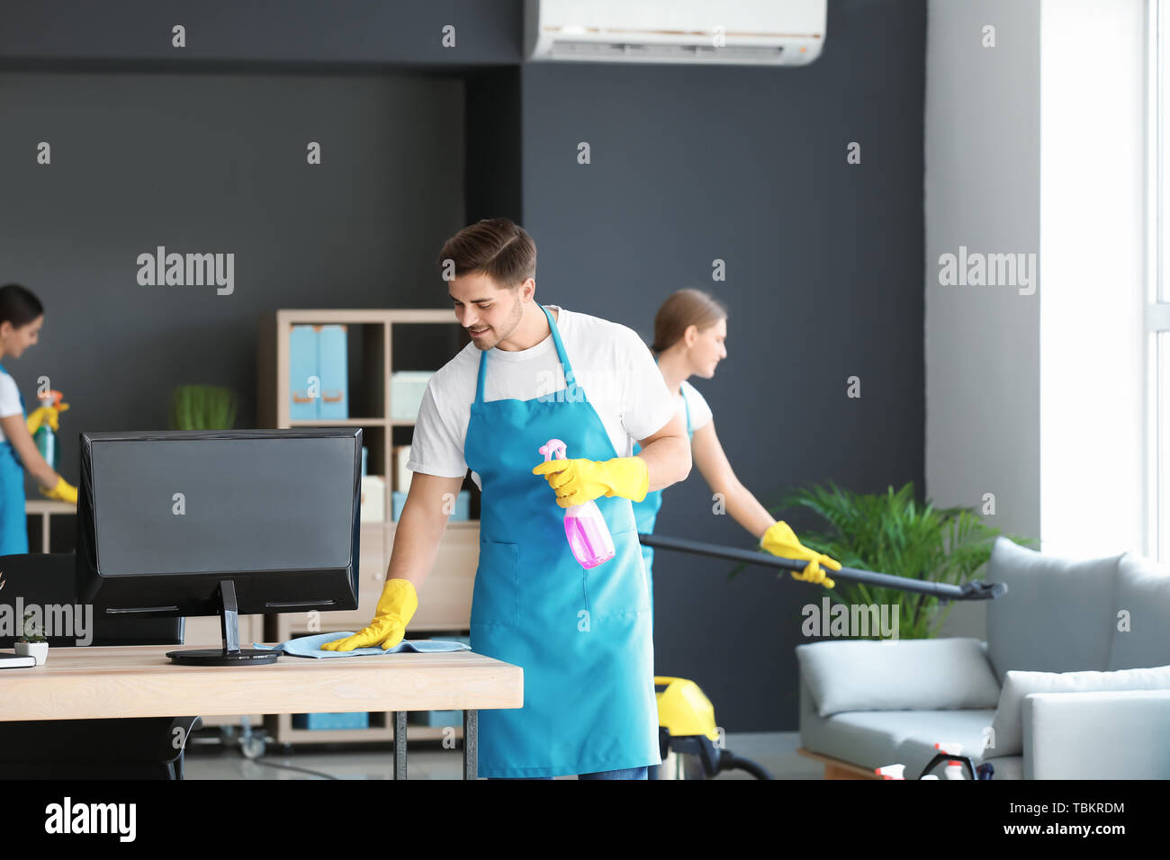 Team of janitors cleaning office Stock Photo - Alamy
