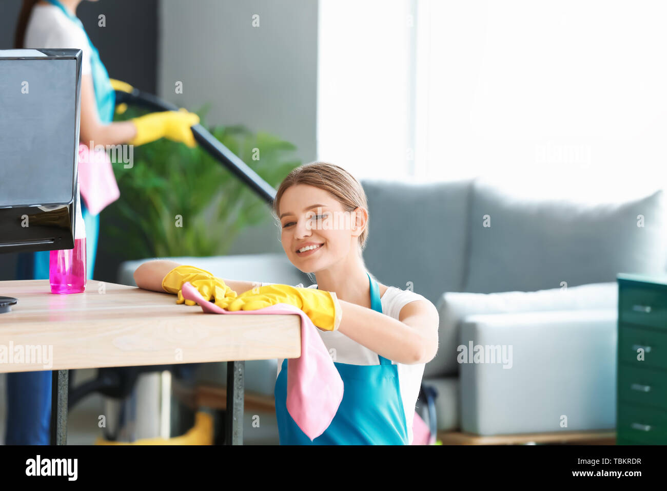 Female janitor cleaning office Stock Photo - Alamy