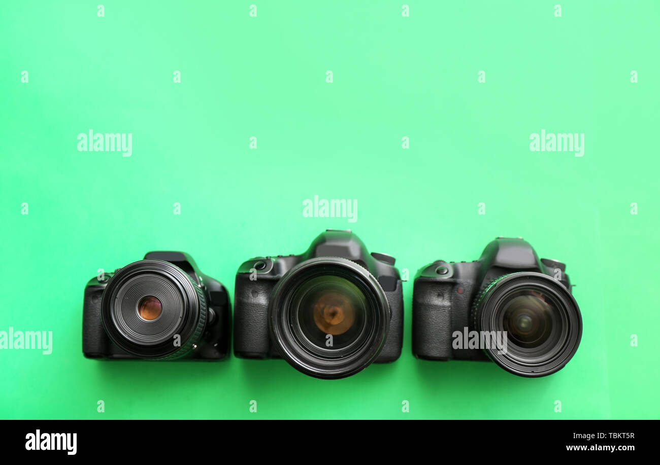 Different professional photo cameras on color background Stock Photo ...