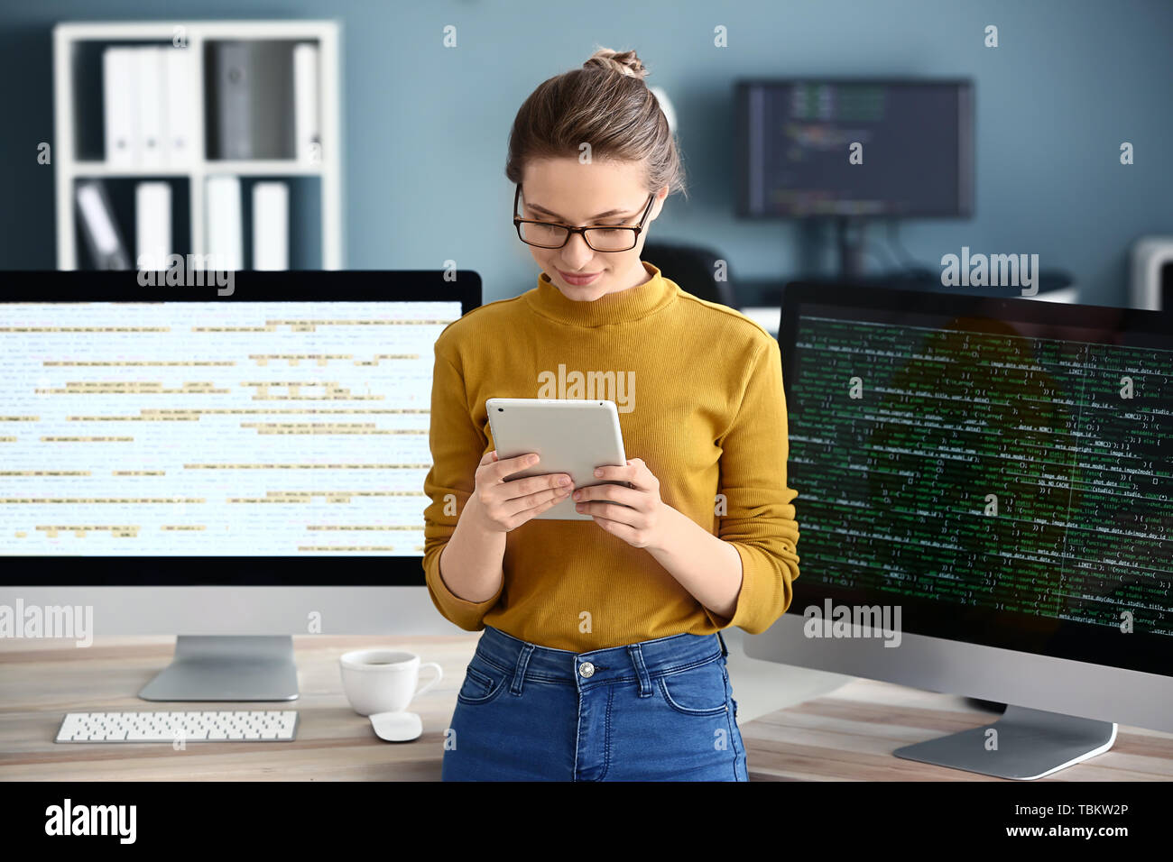 Female programmer working in office Stock Photo - Alamy