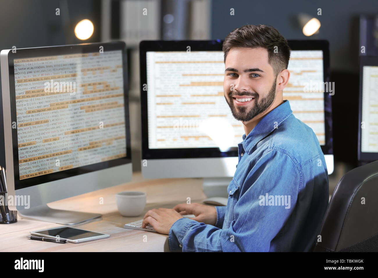 Male programmer working in office Stock Photo - Alamy