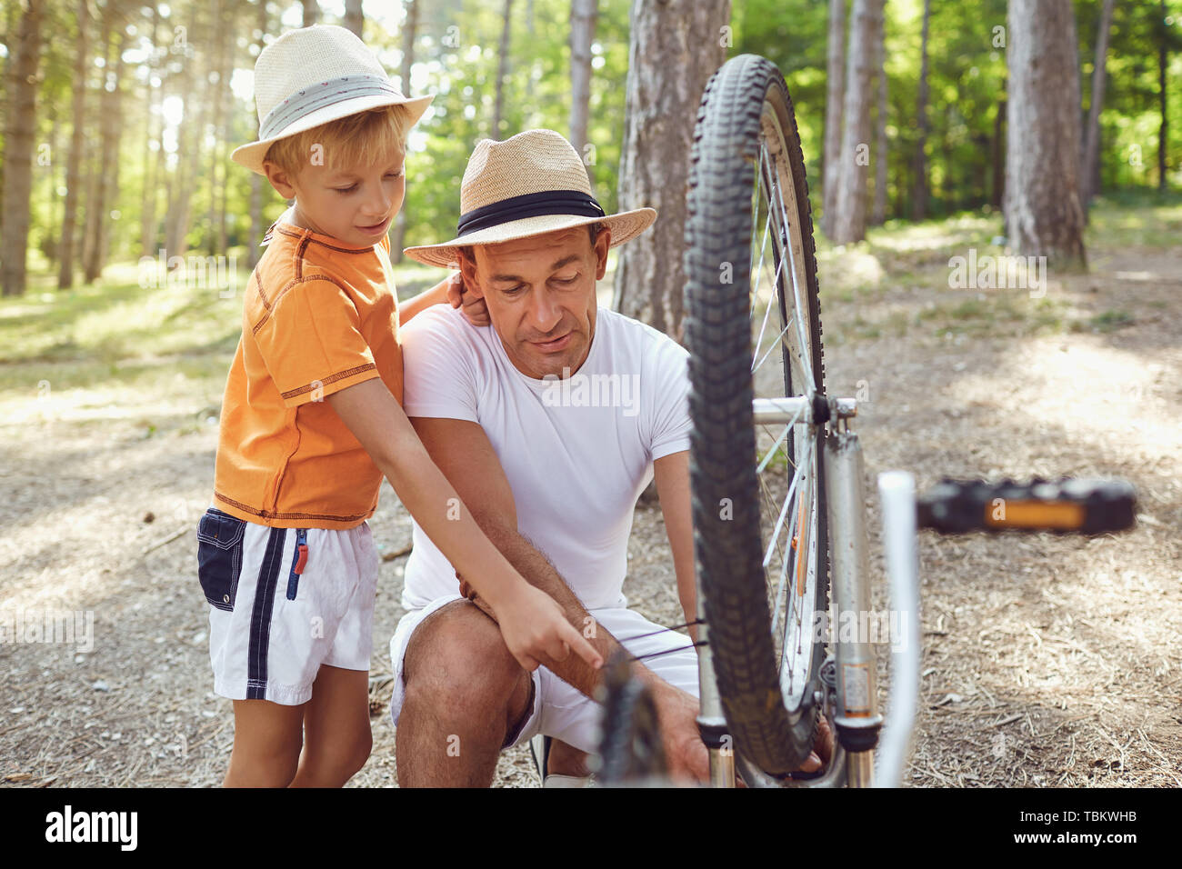 Father son repairing bike together hi-res stock photography and images ...