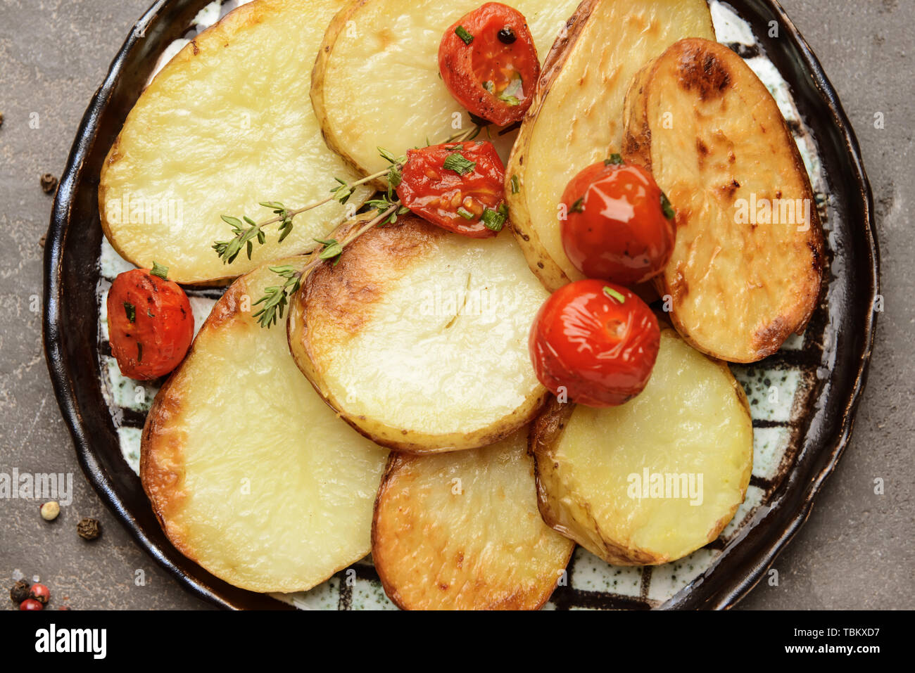 Plate with tasty baked potato on grey table Stock Photo - Alamy