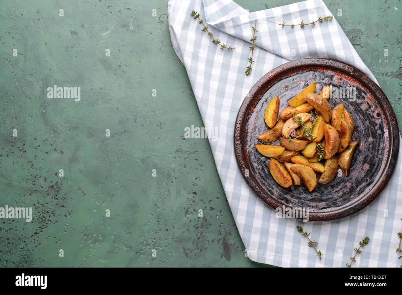 Plate with tasty baked potato on color background Stock Photo - Alamy