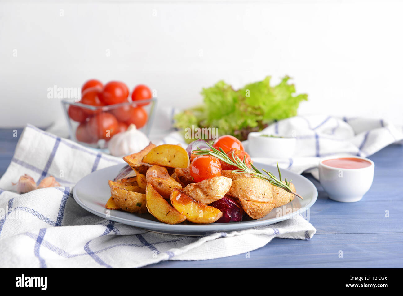 Plate with tasty baked potato on table Stock Photo - Alamy
