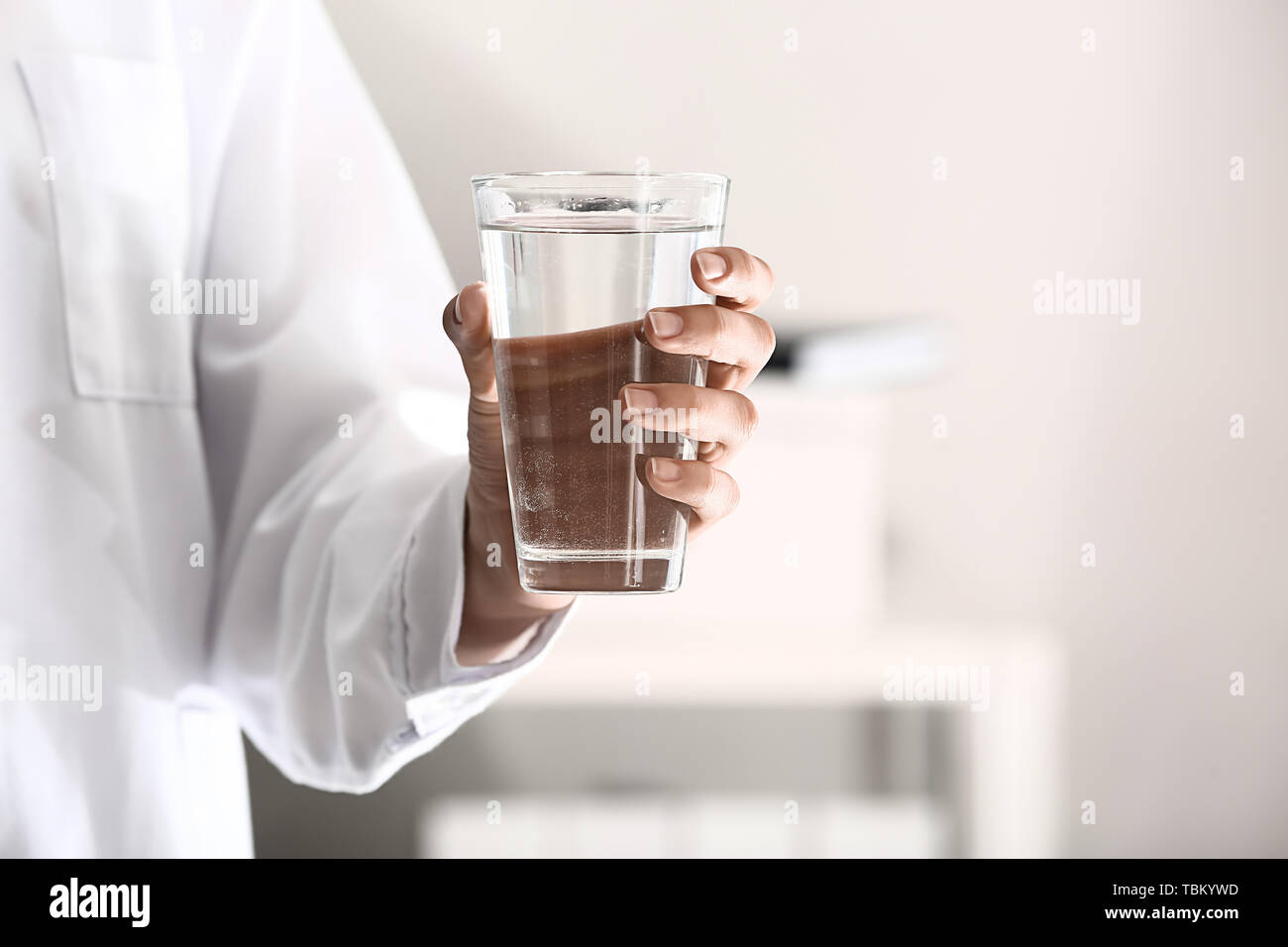 Female doctor drinking water hi-res stock photography and images - Alamy