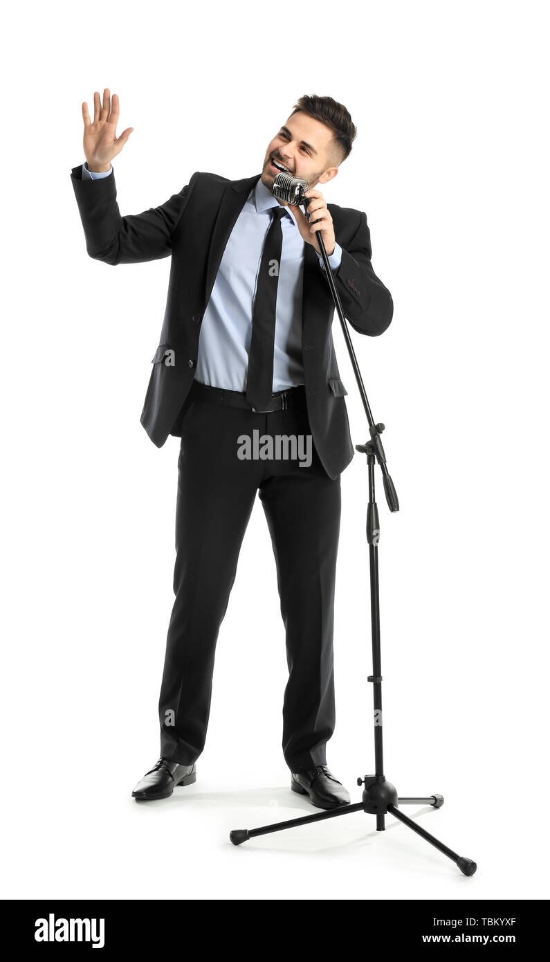 Handsome male singer with microphone on white background Stock Photo ...