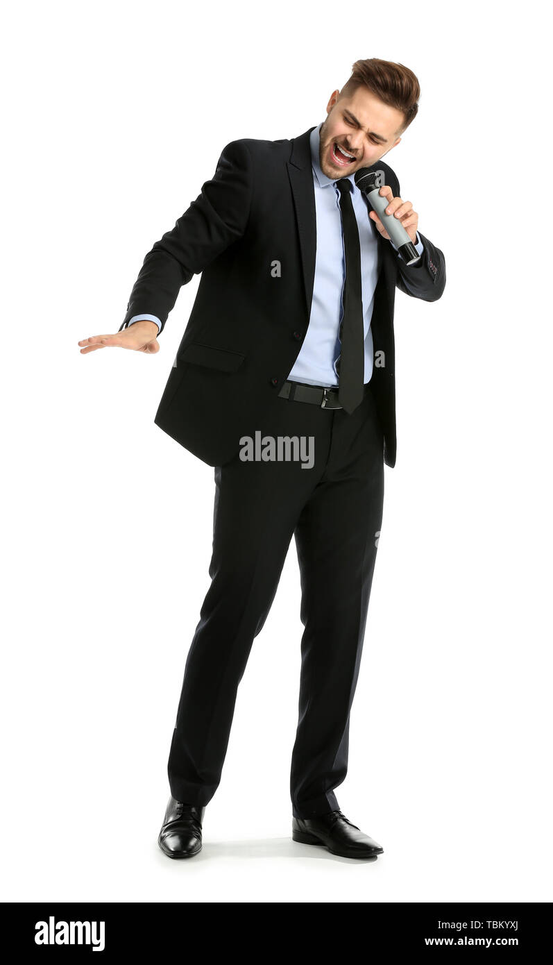 Handsome male singer with microphone on white background Stock Photo ...