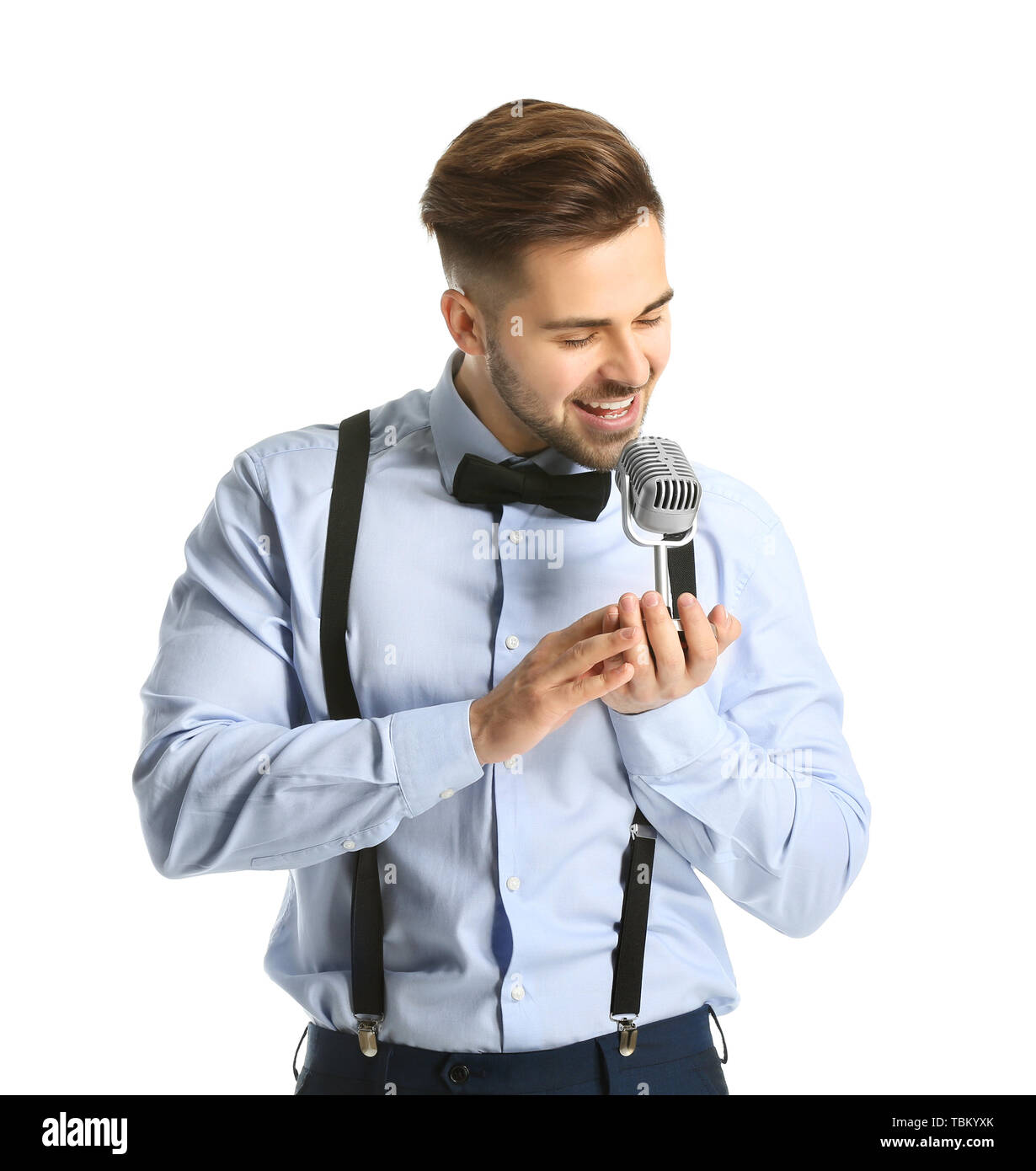 Handsome male singer with microphone on white background Stock Photo ...