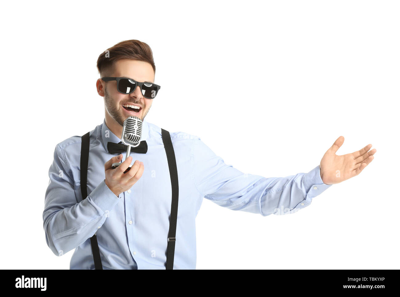 Handsome male singer with microphone on white background Stock Photo ...